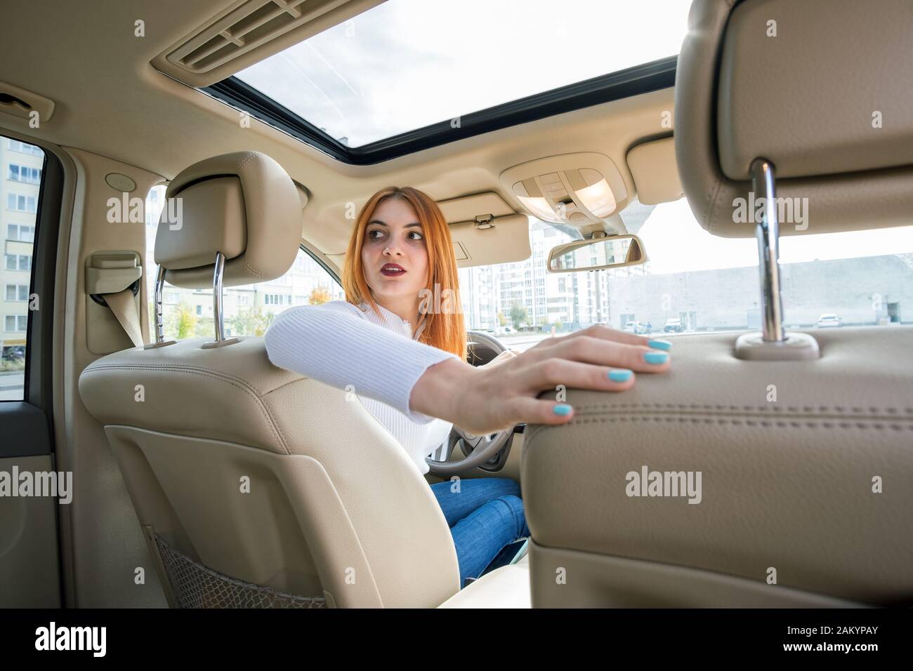 Woman driving reversing car looking hi-res stock photography and images ...