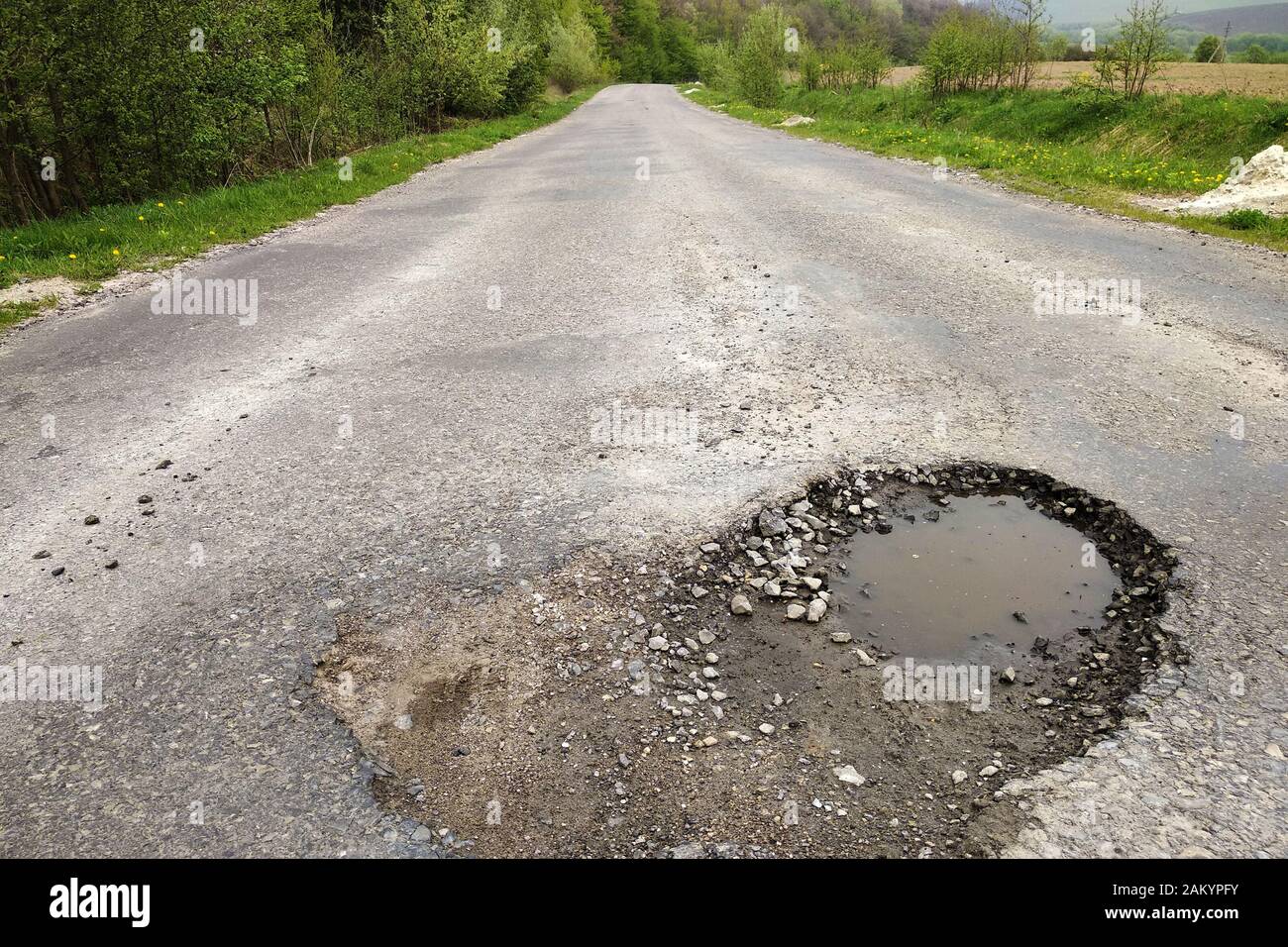 Close up of big pothole with dirty rain water of the road Stock Photo ...