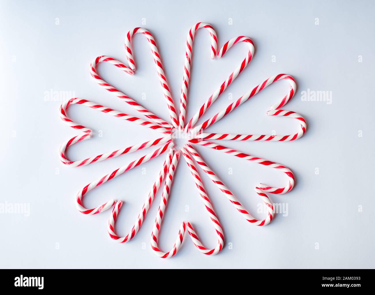 Candy canes arranged in heart shapes on a plain white background Stock ...