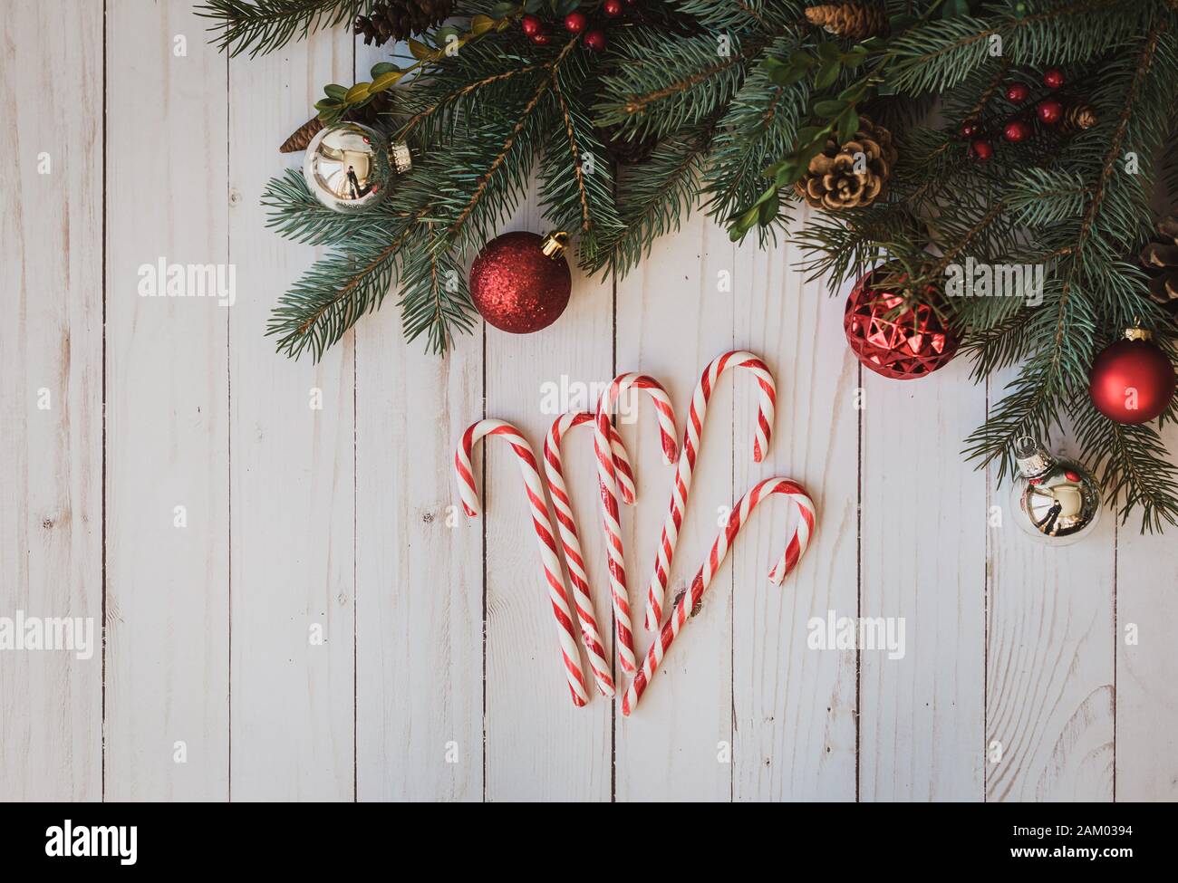 Candy canes on white wood backdrop with Christmas decorations Stock ...