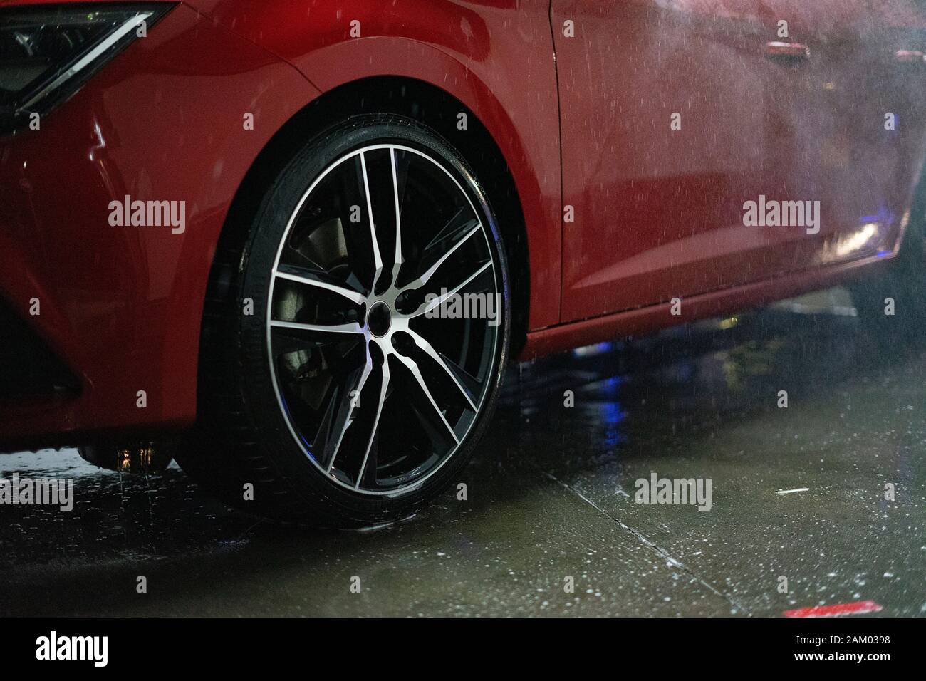 Wheel of a red car in the rain. Concept of driving in the rain Stock ...