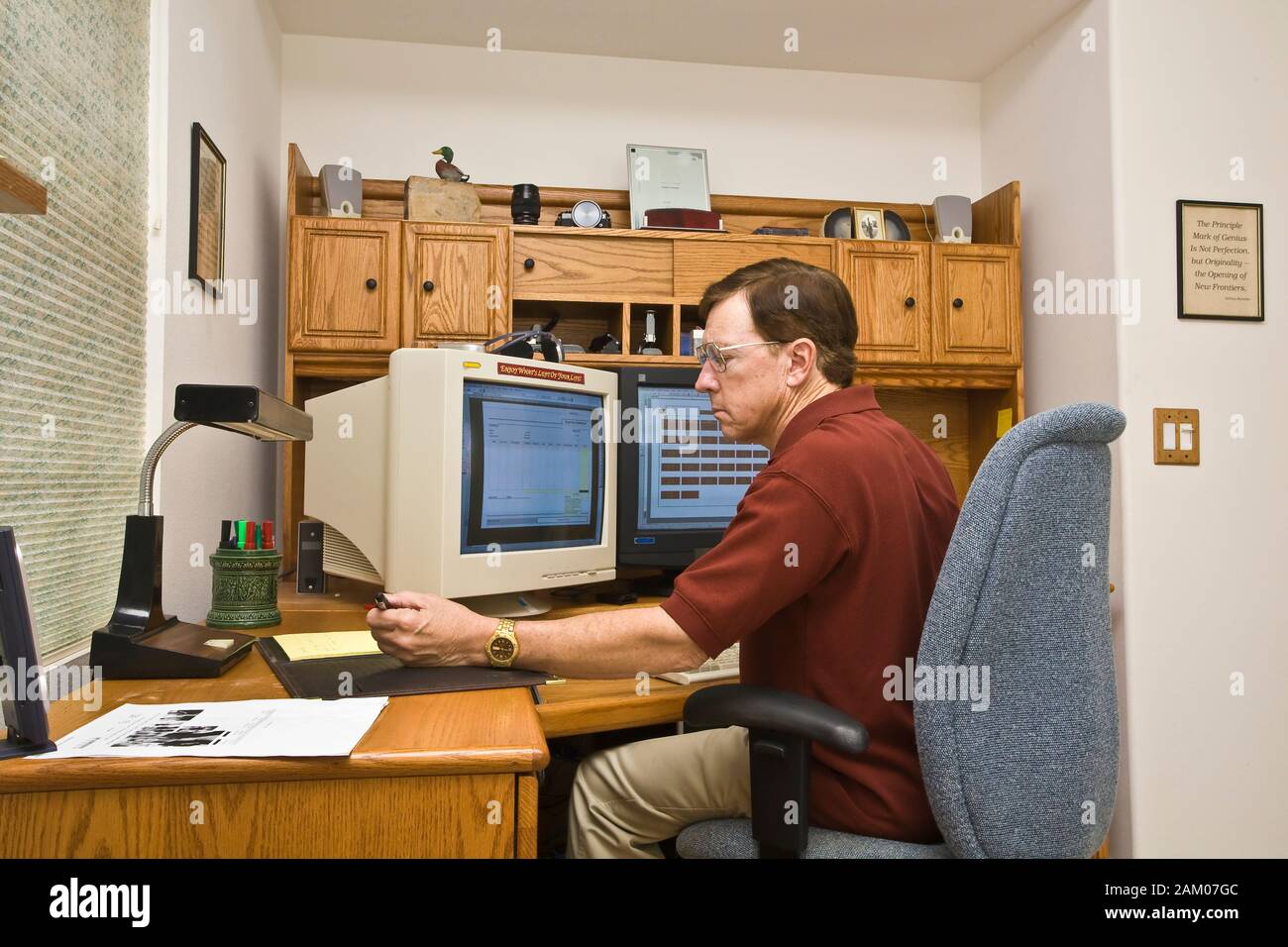 Older man wearing glasses with computer hi-res stock photography and ...