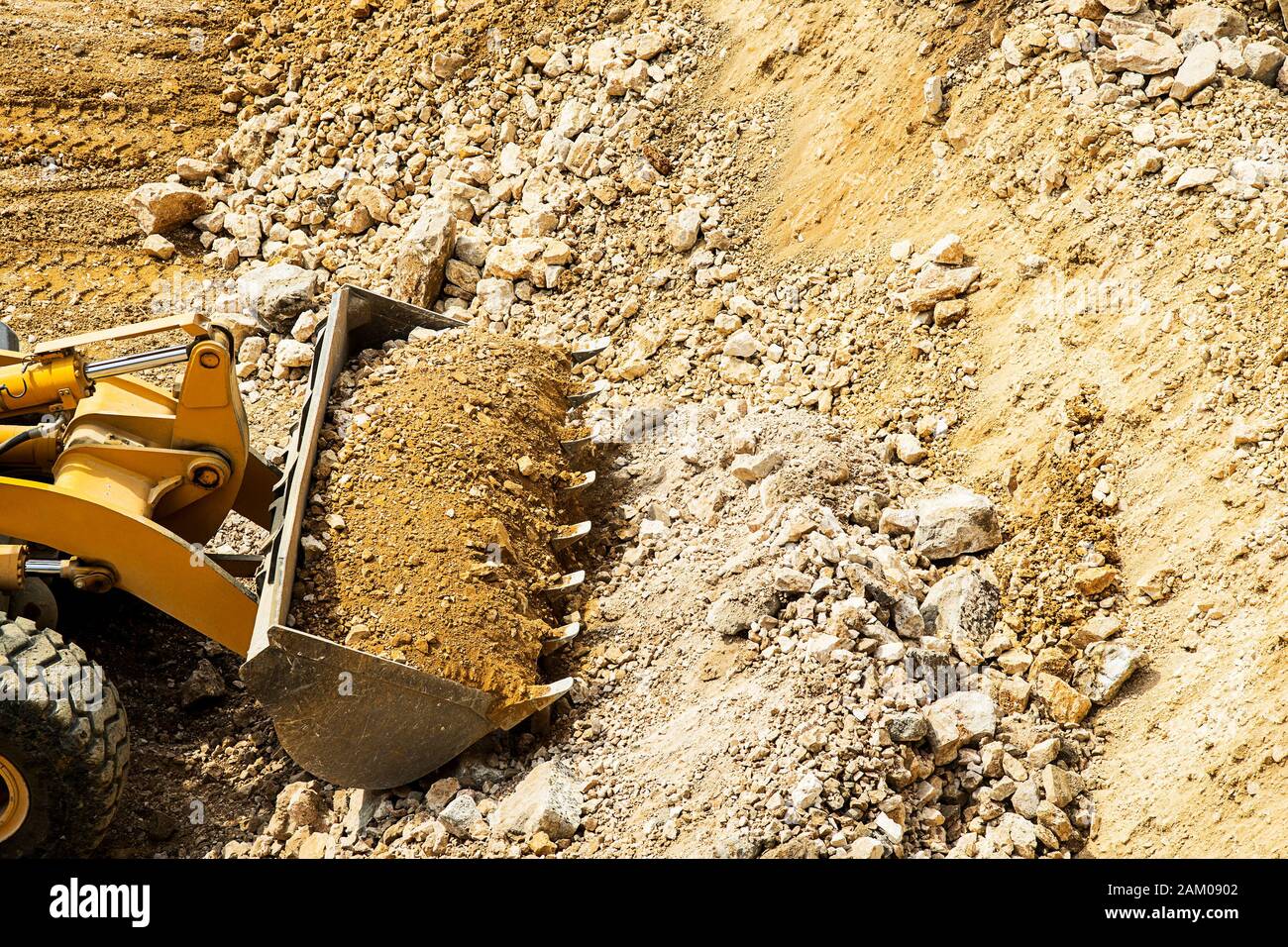 Excavator machine is moving some earth and rocks around the ...