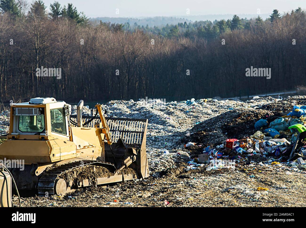 Buldozer and a pile of plastic trash Stock Photo - Alamy