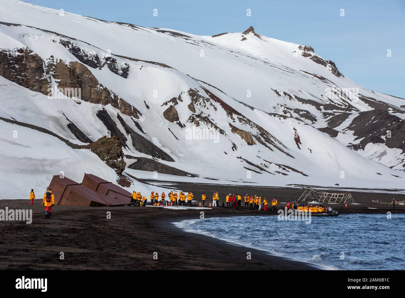 Tourists walking on the beach at Deception Island, South Shetland ...