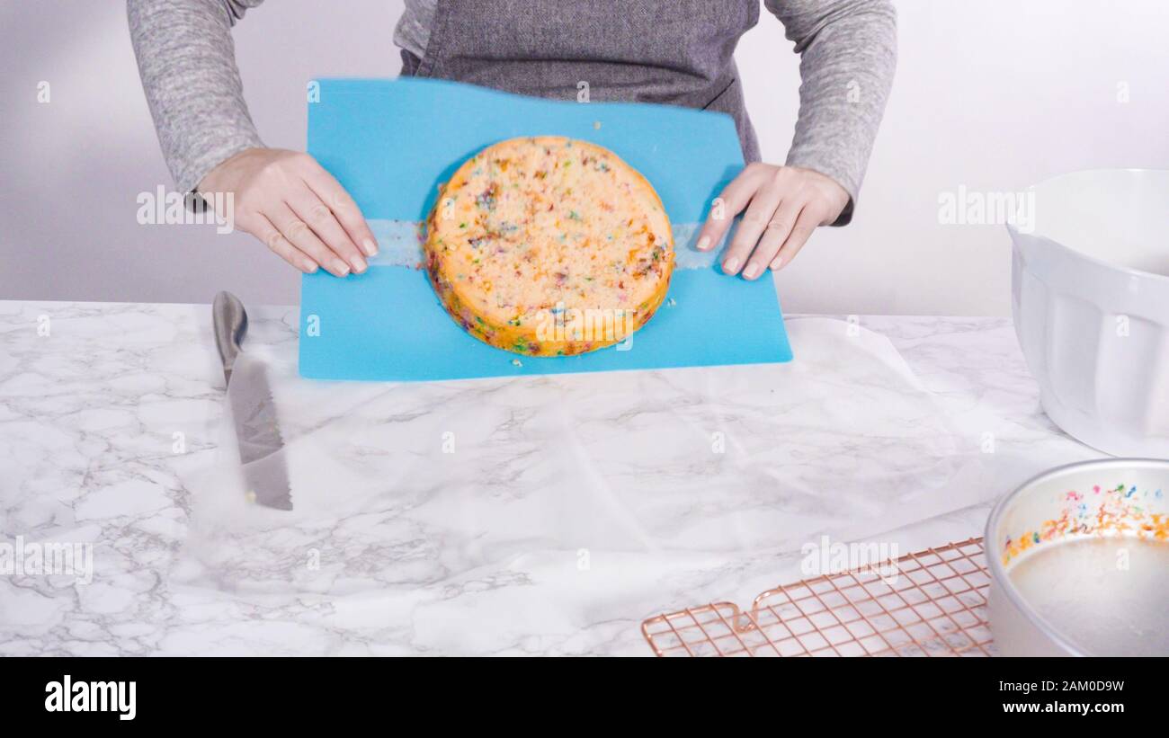 Step by step. Wrapping freshly baked funfetti cake into cellophane and ...