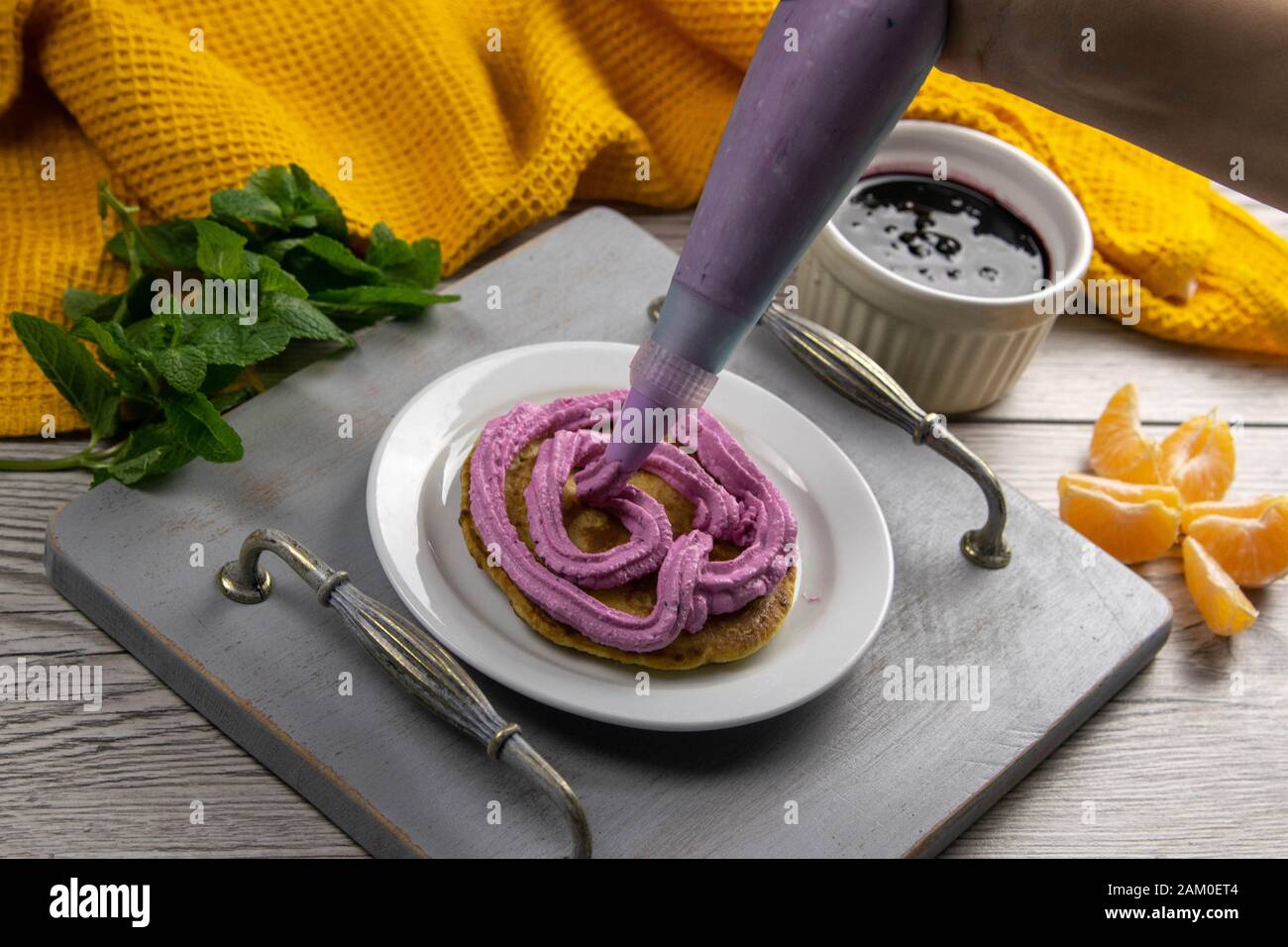 Pancakes poured cream with cottage cheese and blueberries on a ...