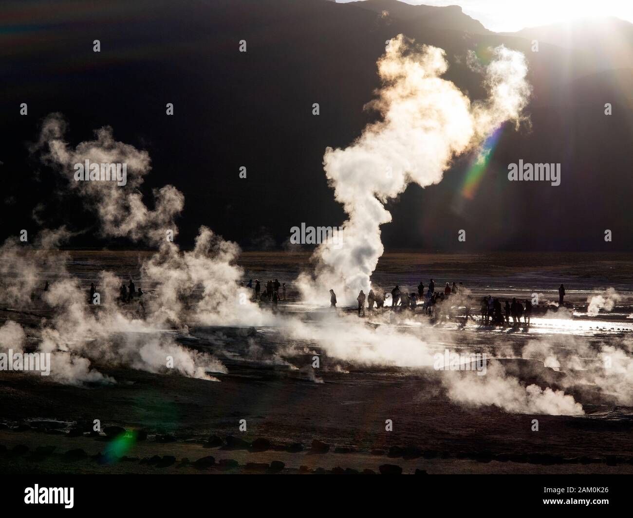Tourists visiting the famous Geiser del Tatio at sunrise, Atacama ...