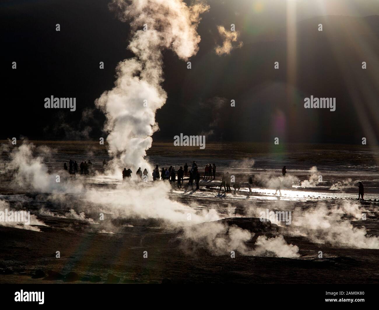 Tourists visiting the famous Geiser del Tatio at sunrise, Atacama ...