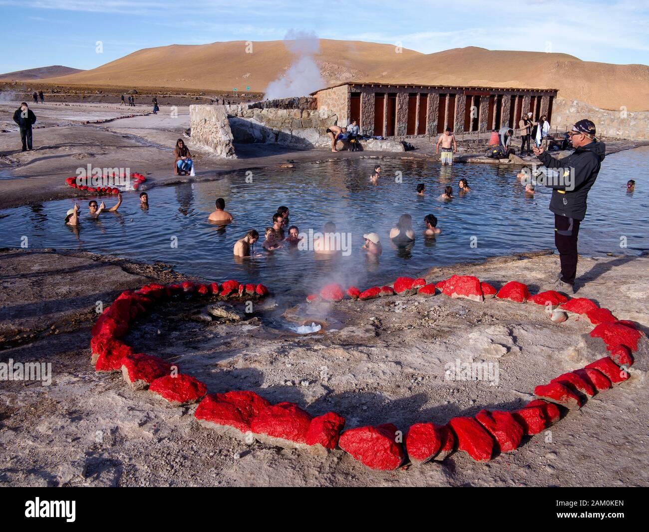 Tourists enjoying the thermal pool at Geiser del Tatio, Atacama Desert ...
