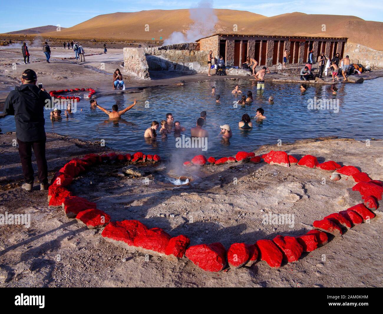 Tourists enjoying the thermal pool at Geiser del Tatio, Atacama Desert ...