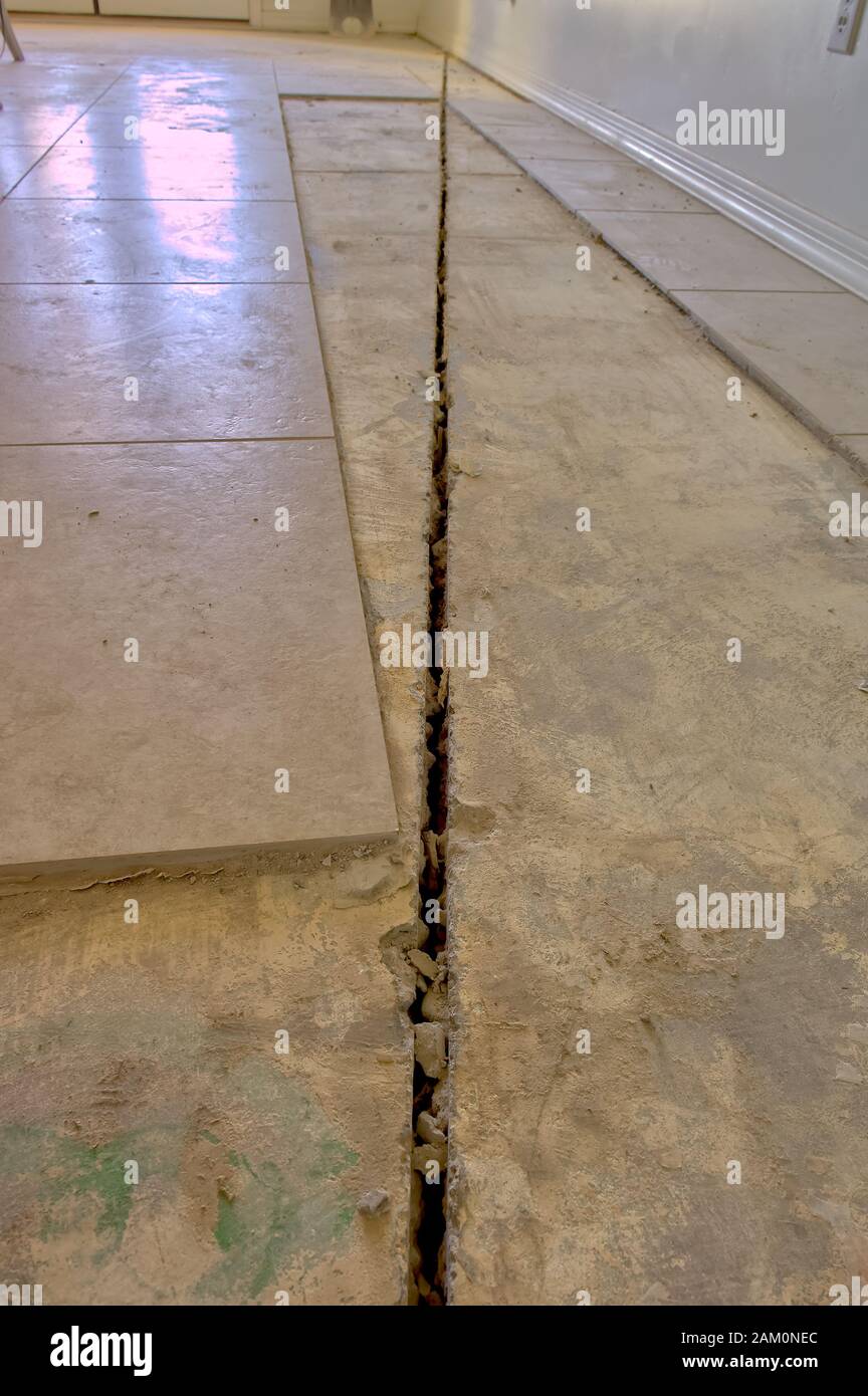 A giant crack in the foundation of a house caused by uneven settlement ...