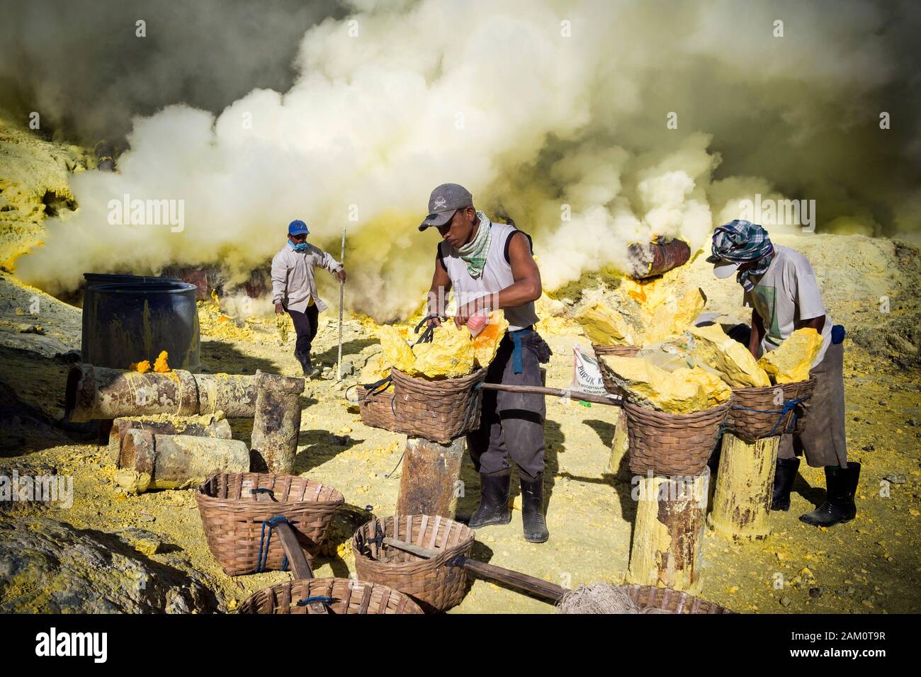 Sulphur miners at work inside the crater of Kawah Ijen volcano in East ...