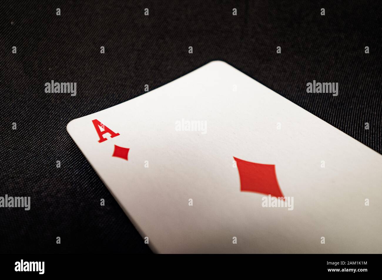 Red Ace of Diamonds on black background Stock Photo - Alamy