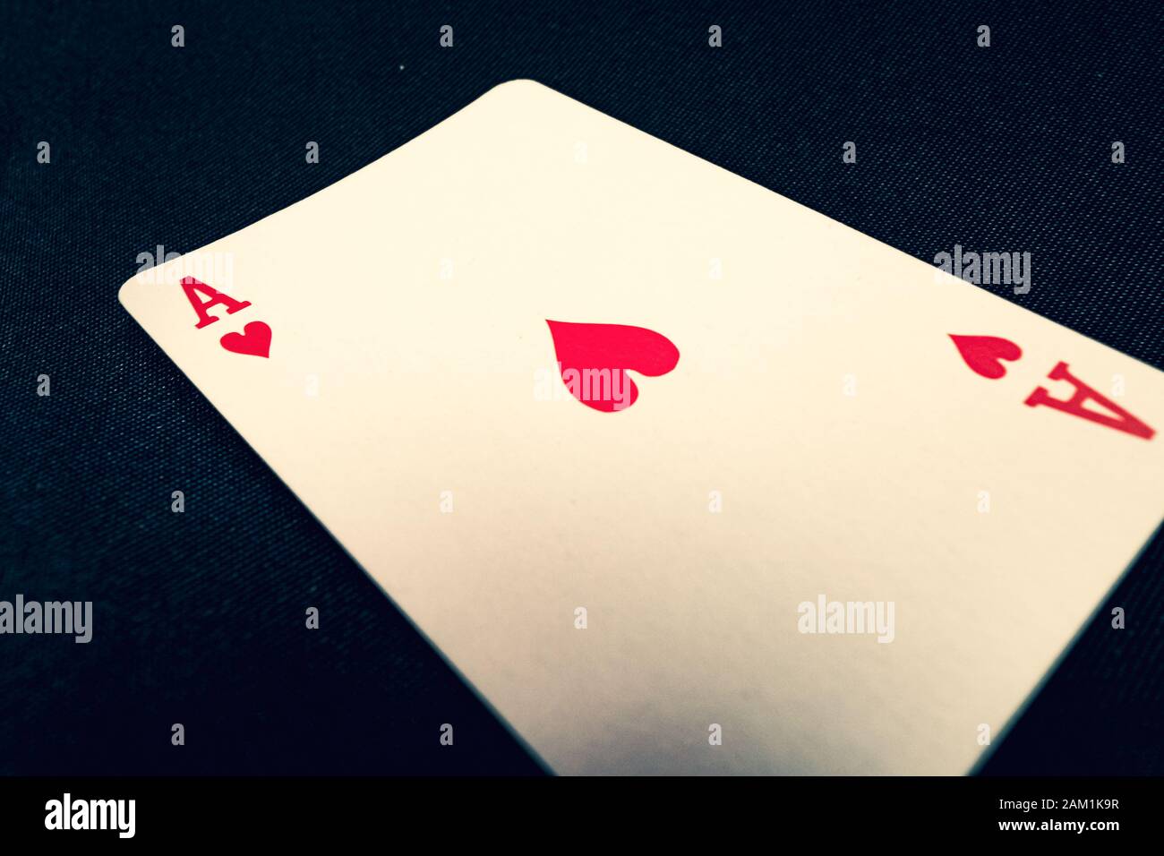 red ace of hearts on black background Stock Photo - Alamy