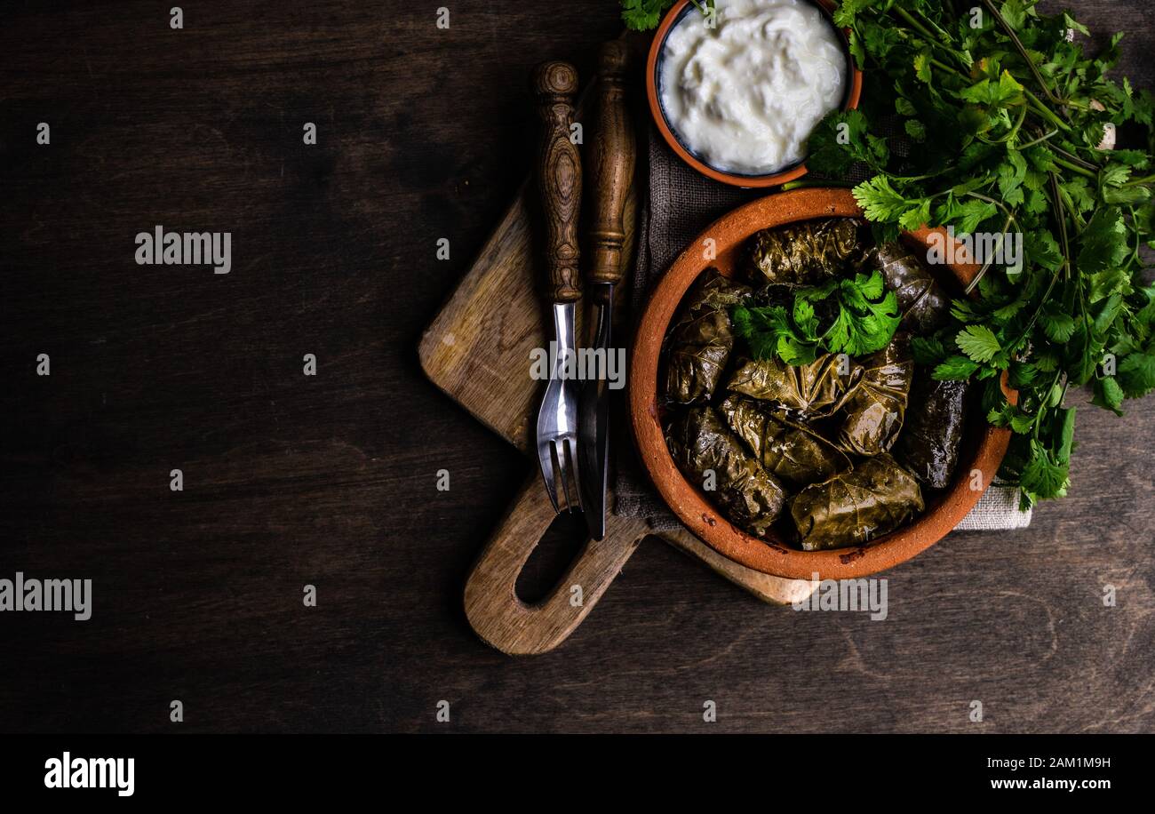 Traditional georgian tolma in vine leaves on rustic background with ...