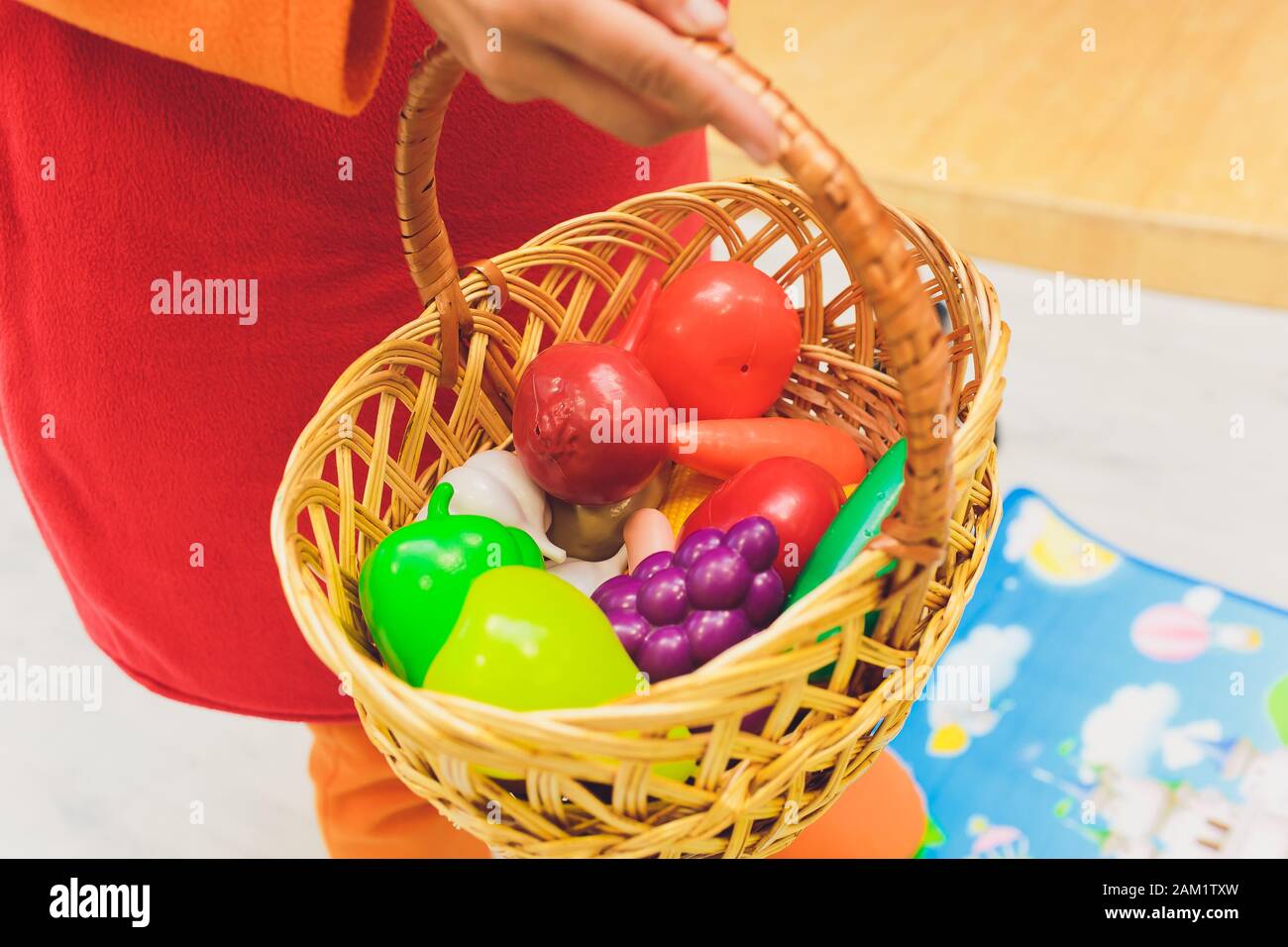 Still life from toy artificial plastic vegetables and fruits in blue ...