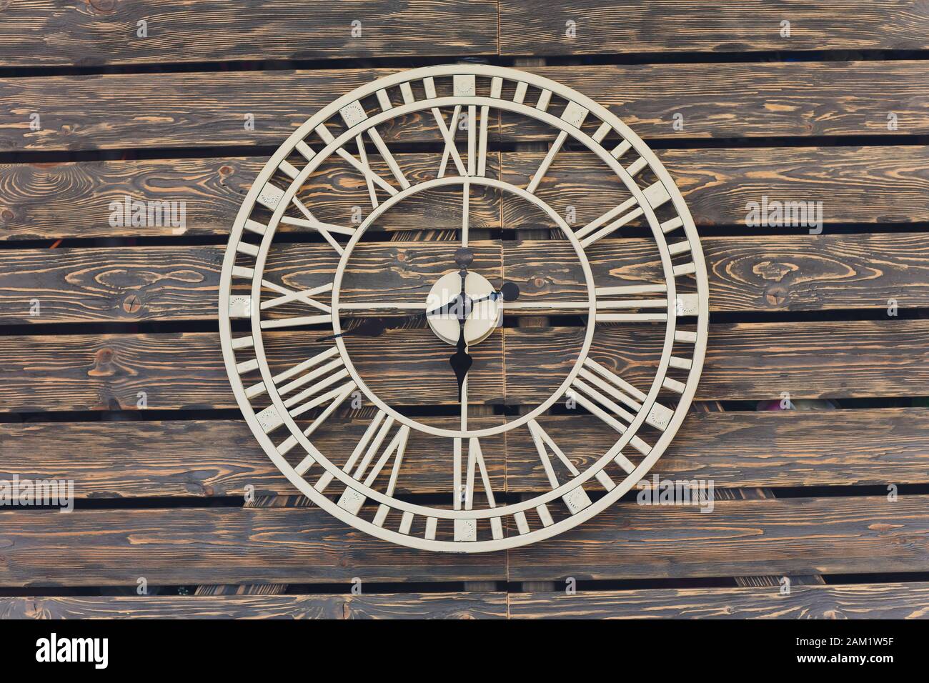 Antique clock on the old, brick wall, wooden floor, smoke, fog. Dark ...
