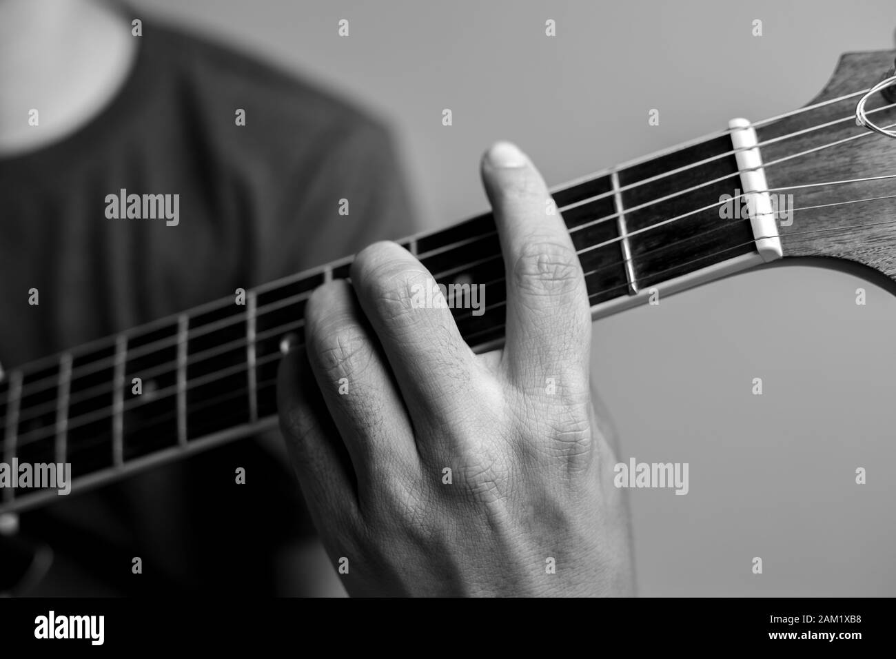Men catch chords are learning to play guitar. Closeup musicians are ...