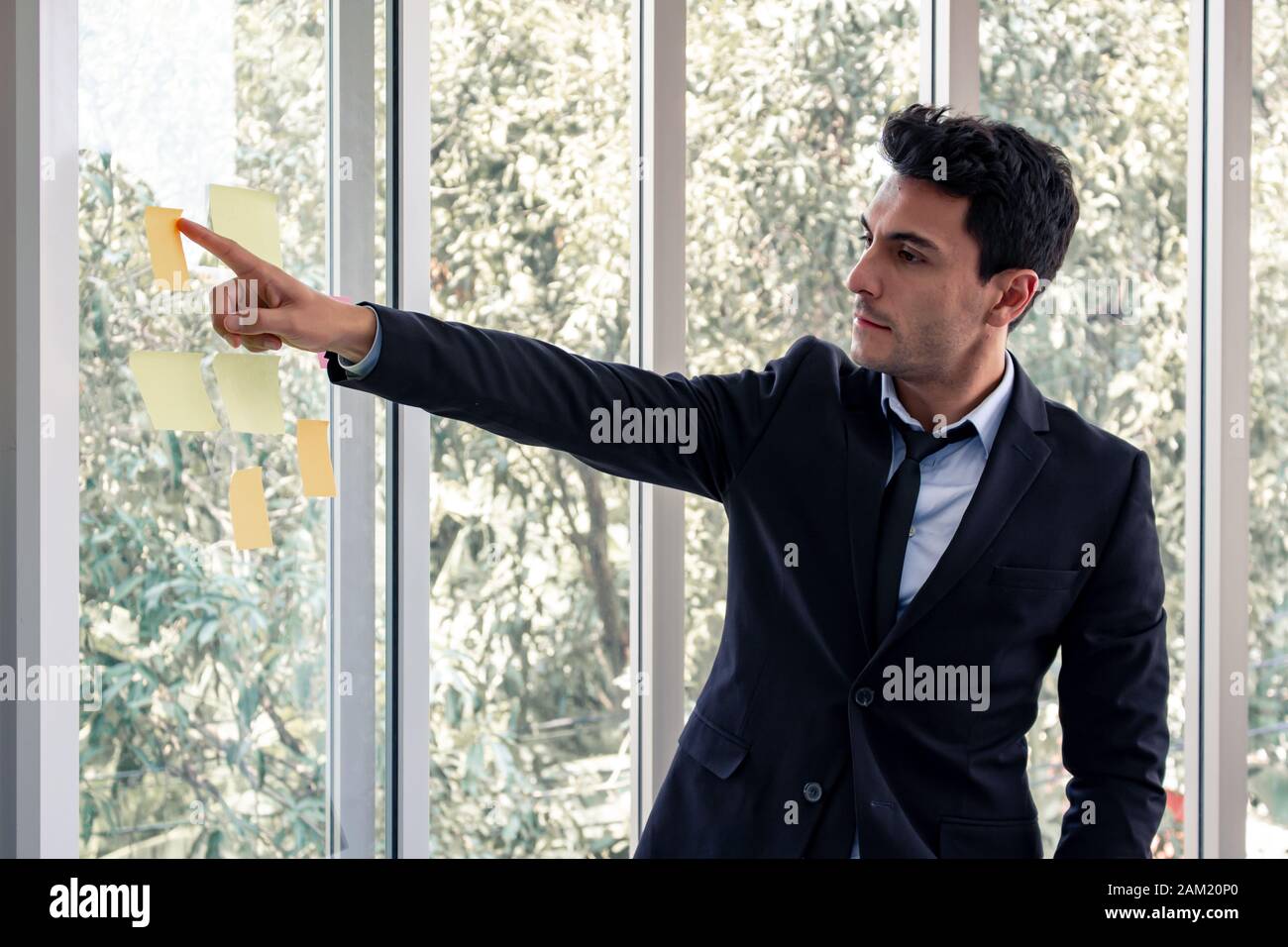 Businessman pointing and explaining the information on the paper that ...