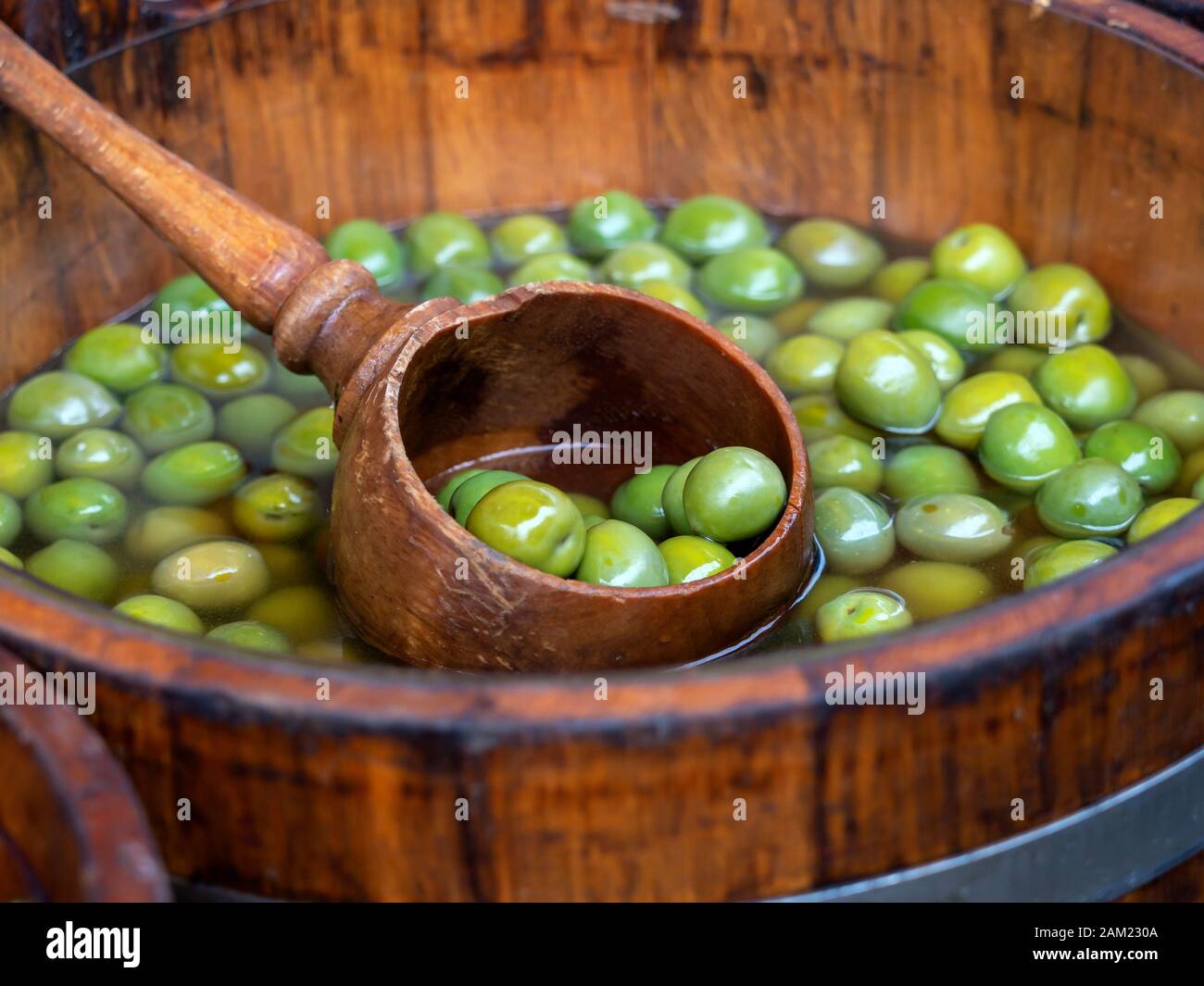 Wooden barrel of green olives with ladle at a Food Market Stock Photo ...