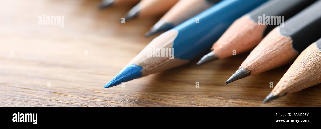 Blue pencil spy between black pencils Stock Photo - Alamy