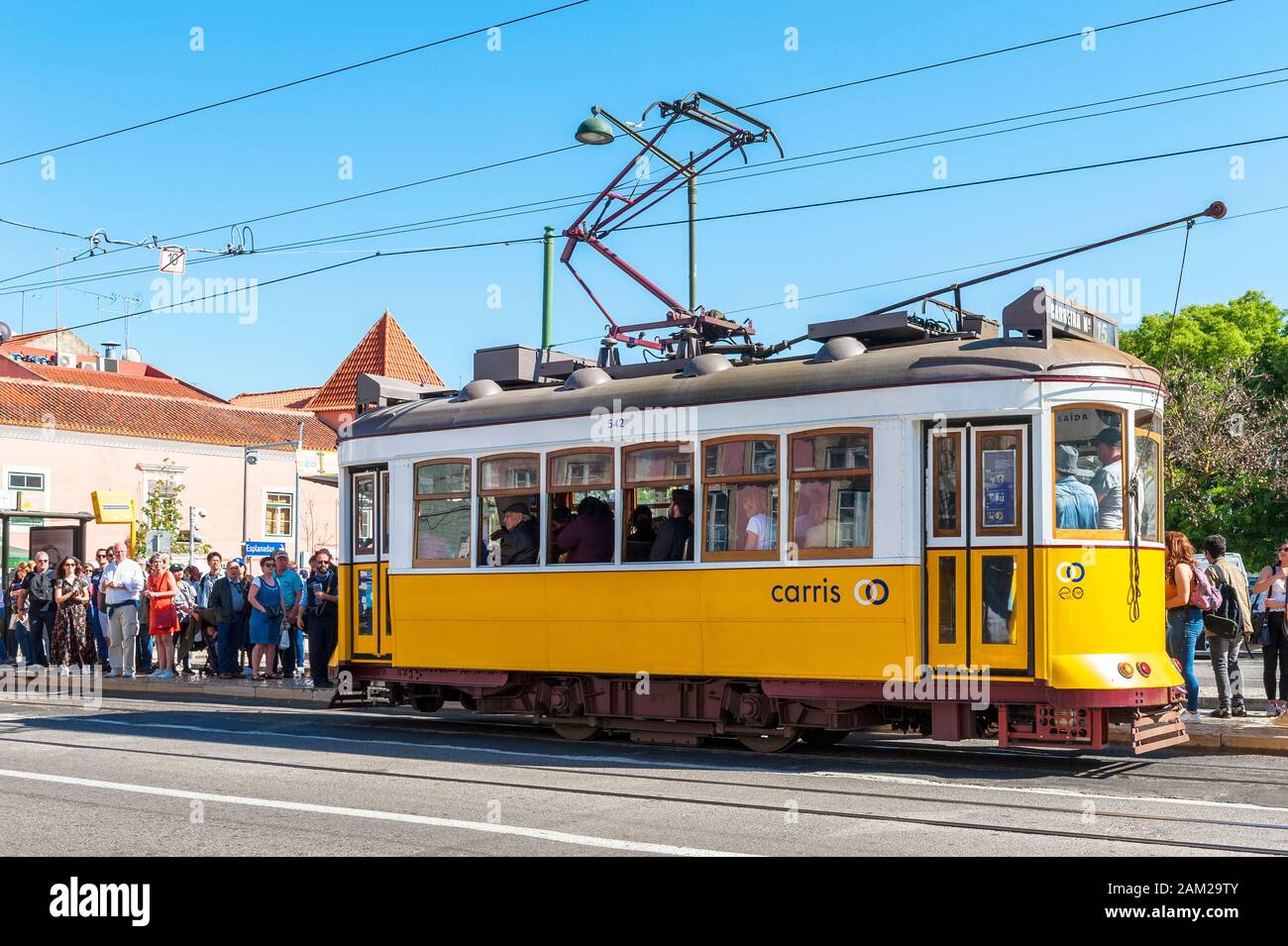 Traditional yellow tram at the street so of Lisboa, Portugal Stock ...