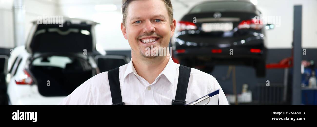 Smiling man worker repair car service portrait Stock Photo - Alamy