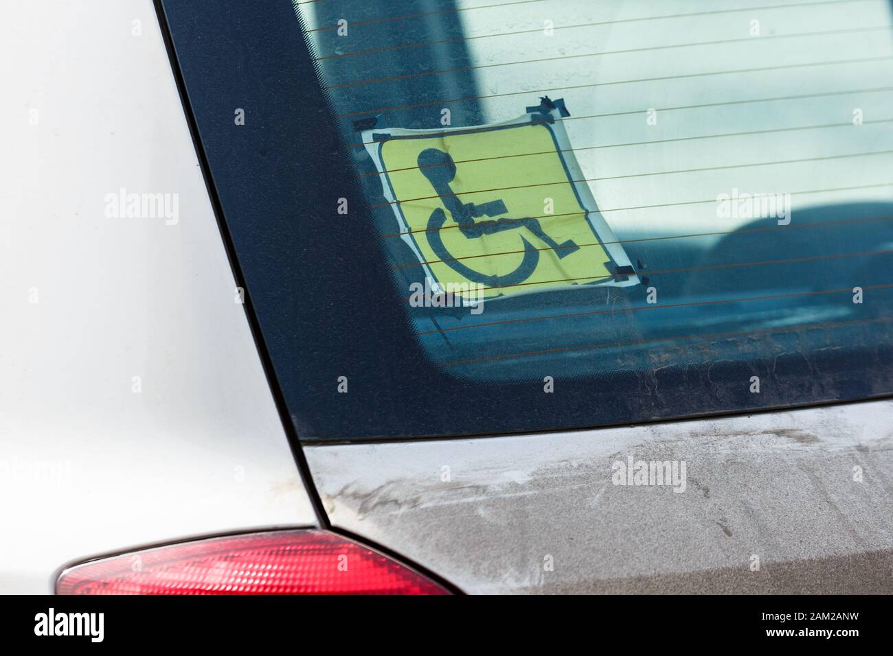 The owner's disability sign on the car window. Car of a person with a ...