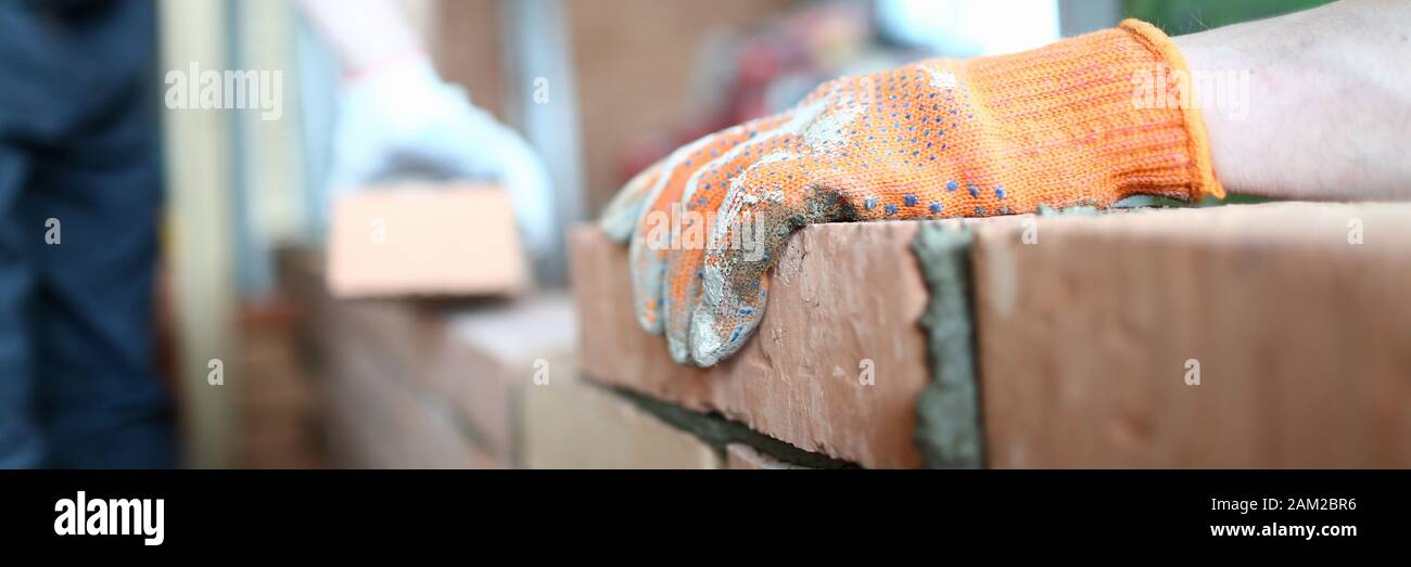 Skilled builder with bricks Stock Photo - Alamy