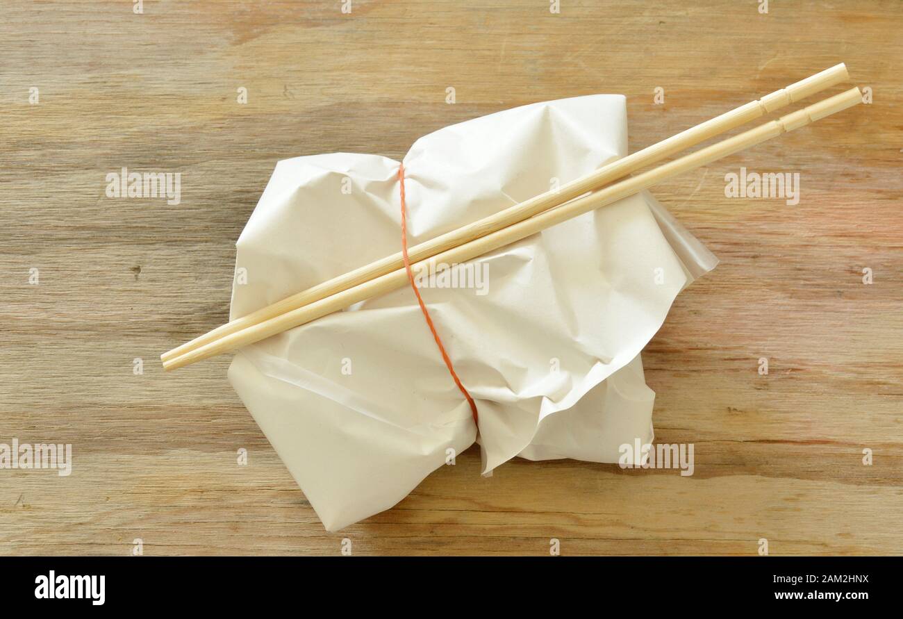 ready meal in paper packing by rubber band and wooden chopsticks Stock ...