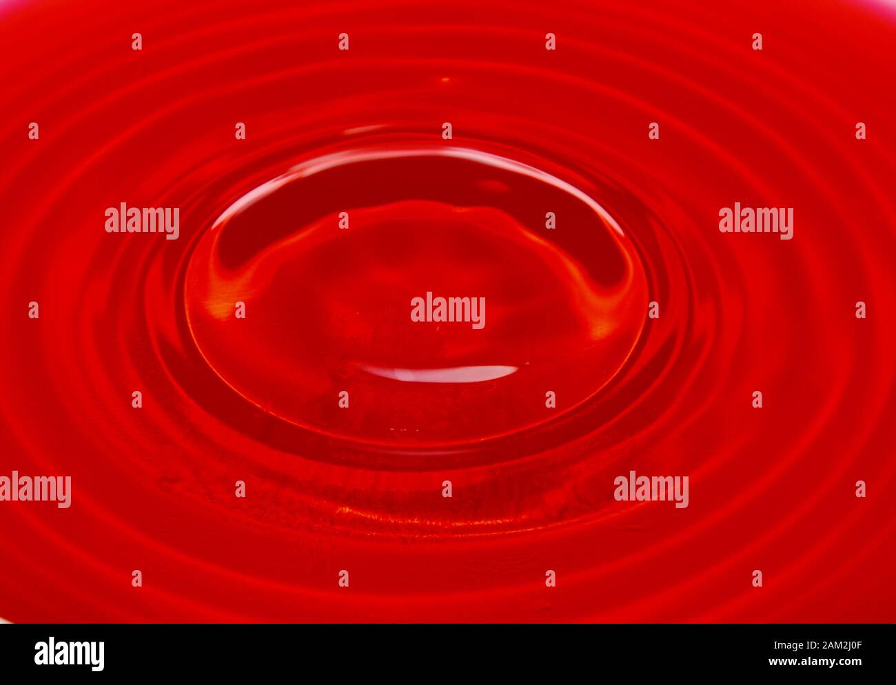 drop of water falling and splash on red background Stock Photo - Alamy