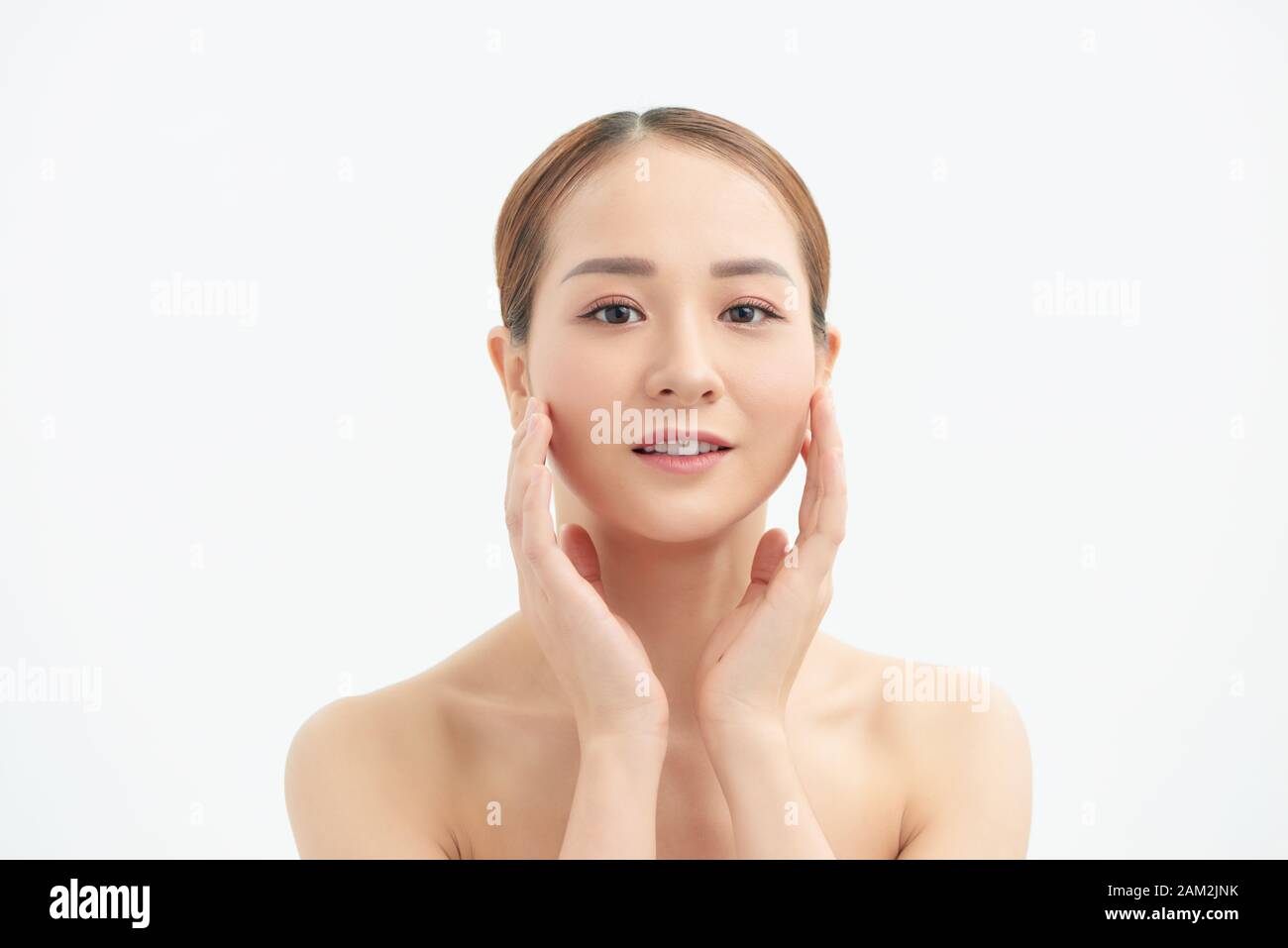 Young woman touching her face isolated on white background Stock Photo ...