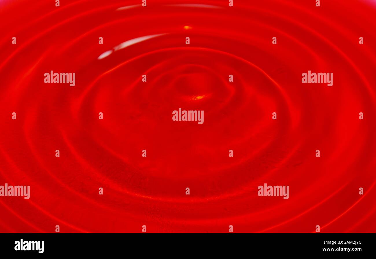 drop of water falling and splash on red background Stock Photo - Alamy