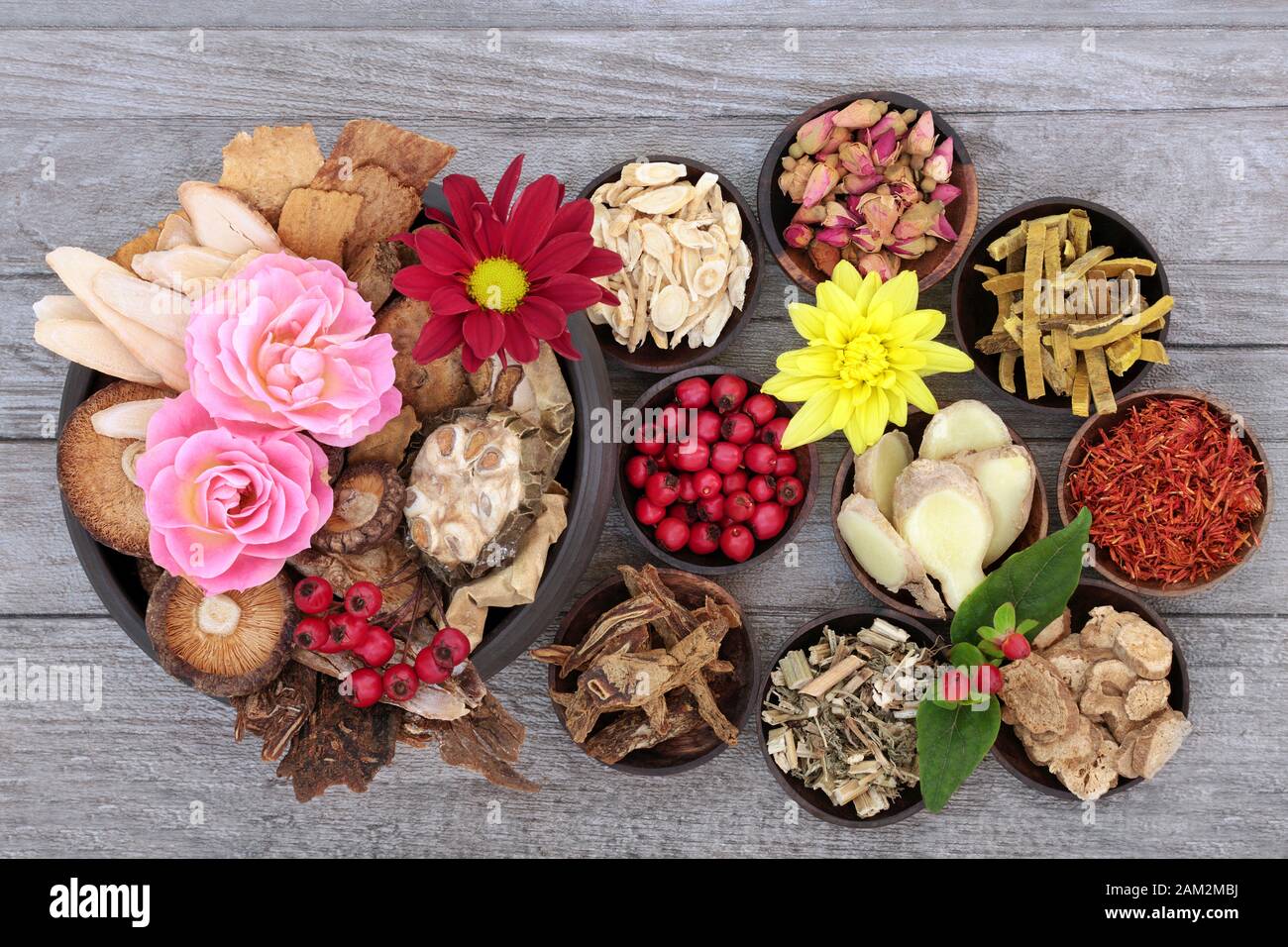 Traditional Chinese herbs and flowers used in herbal medicine on rustic ...