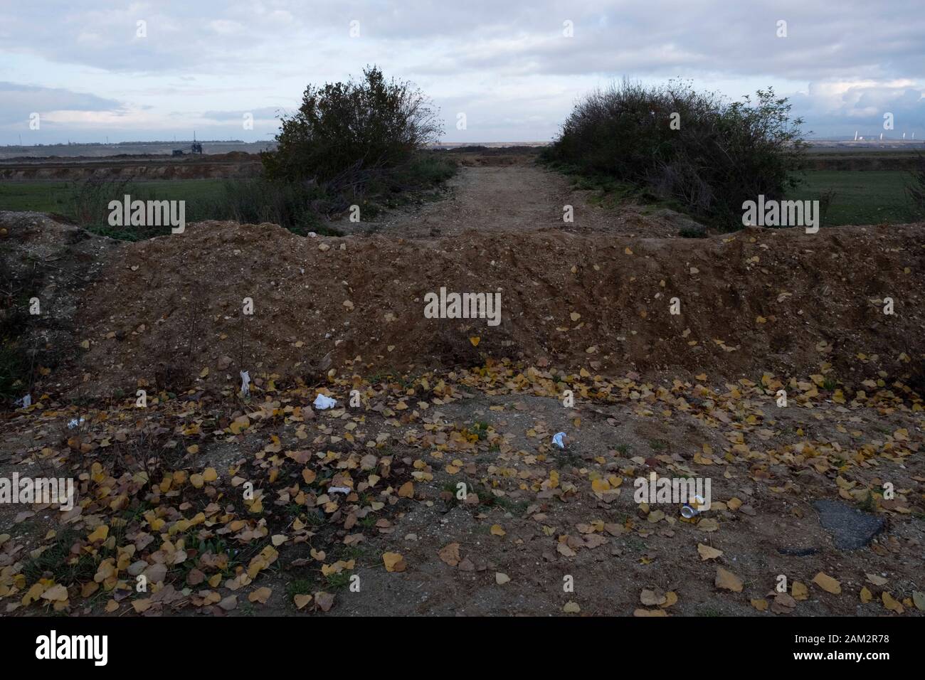 Pile of earth blocking dirt road near open pit coal mine, Garzweiller ...