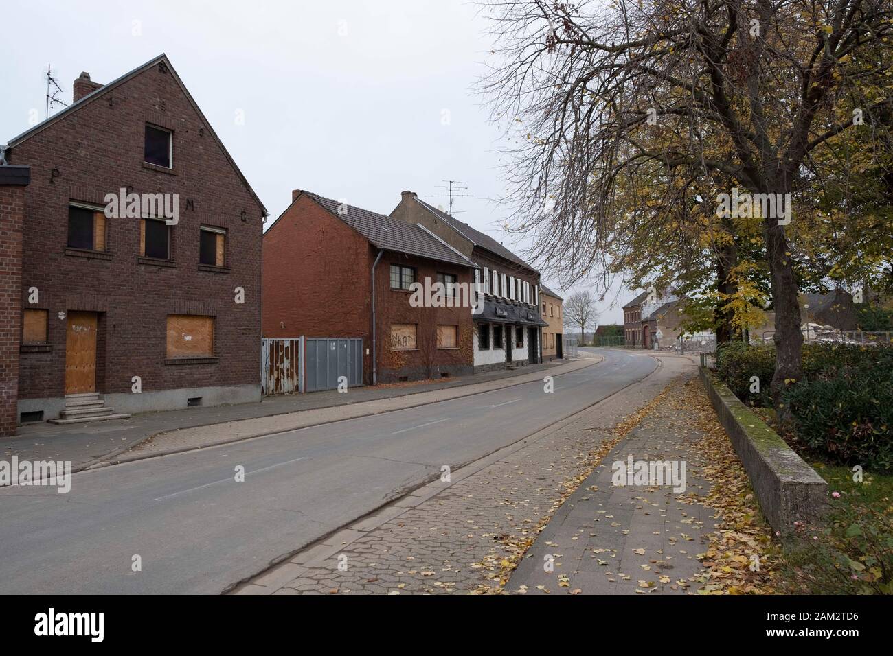 Main road passing by boarded up buildings in abandoned coal mining town ...