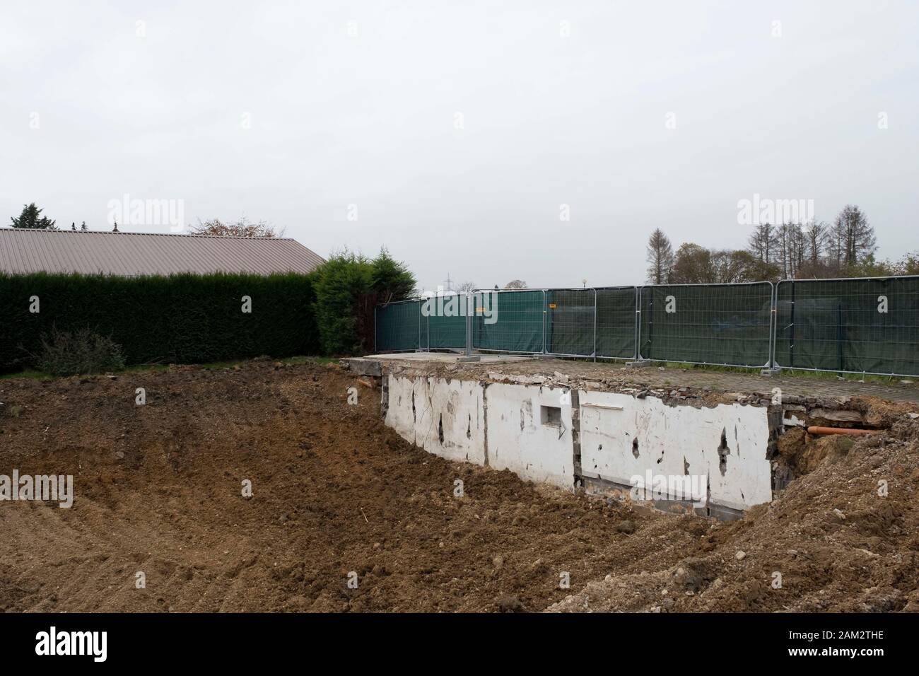 Fenced off excavation of demolished building foundations in abandoned ...