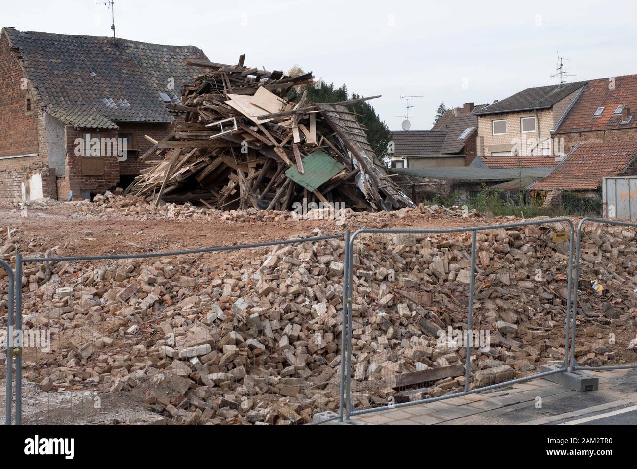 Fenced off pile of rubble from demolished buildings in abandoned coal ...
