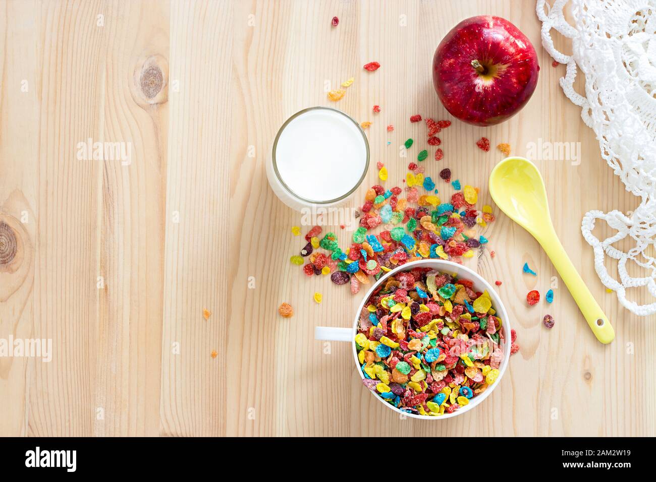 Kids healthy quick breakfast. Colorful rice cereal, milk and red apple ...