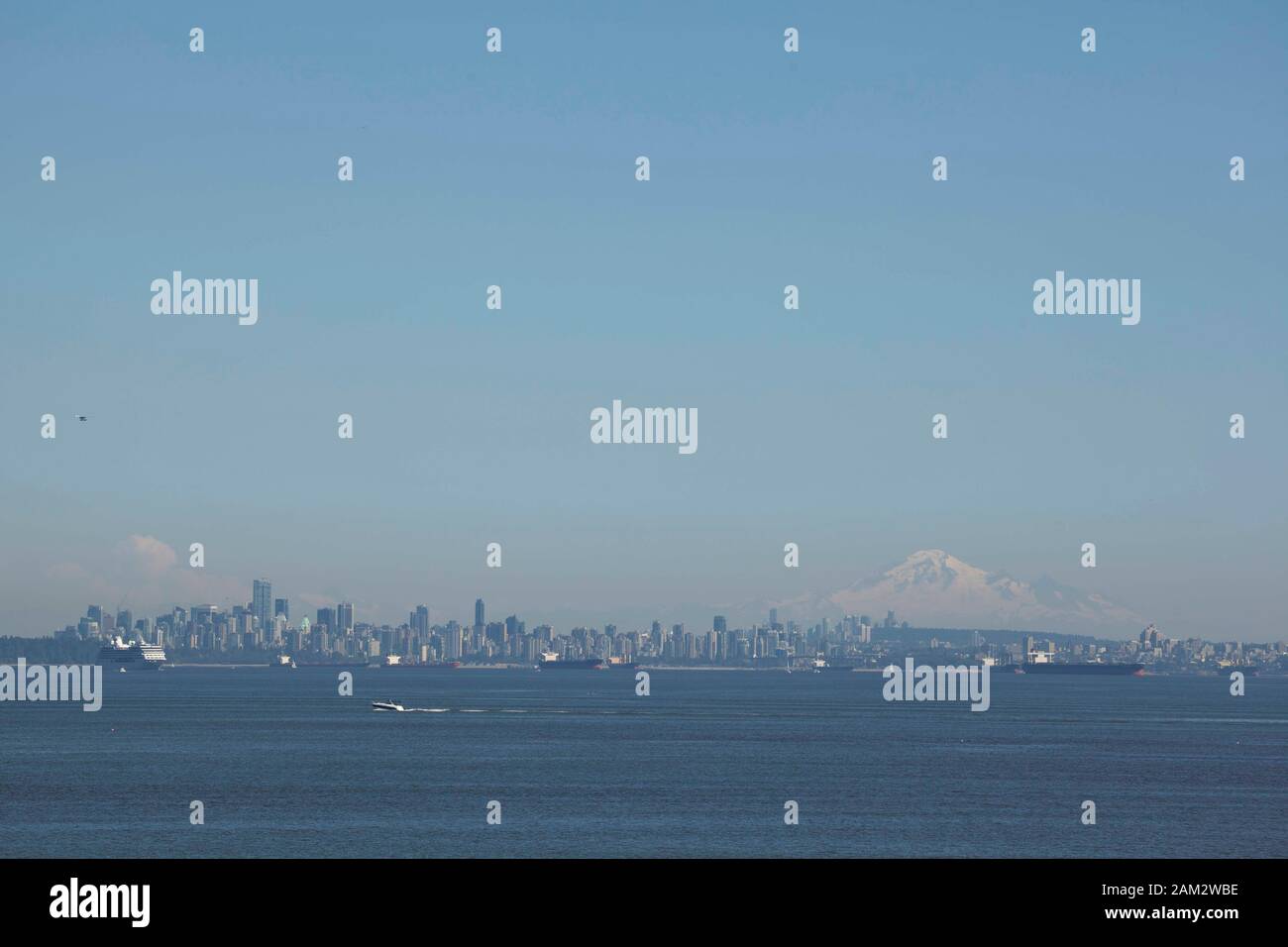 Busy harbour with container ships, cruise ships and boats, Mount Baker ...