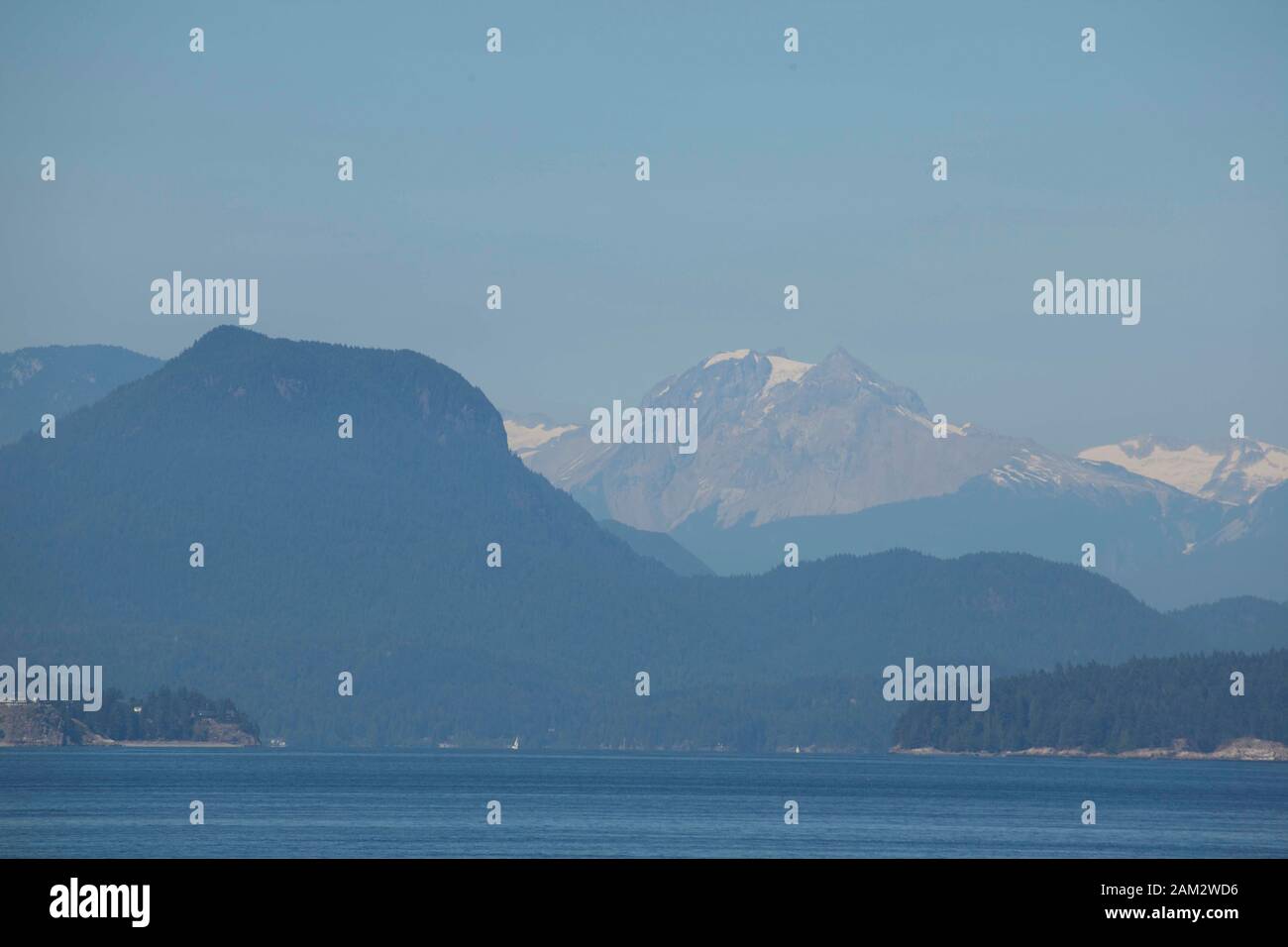 Mountains seen across calm sea from Vancouver Island, British Columbia ...