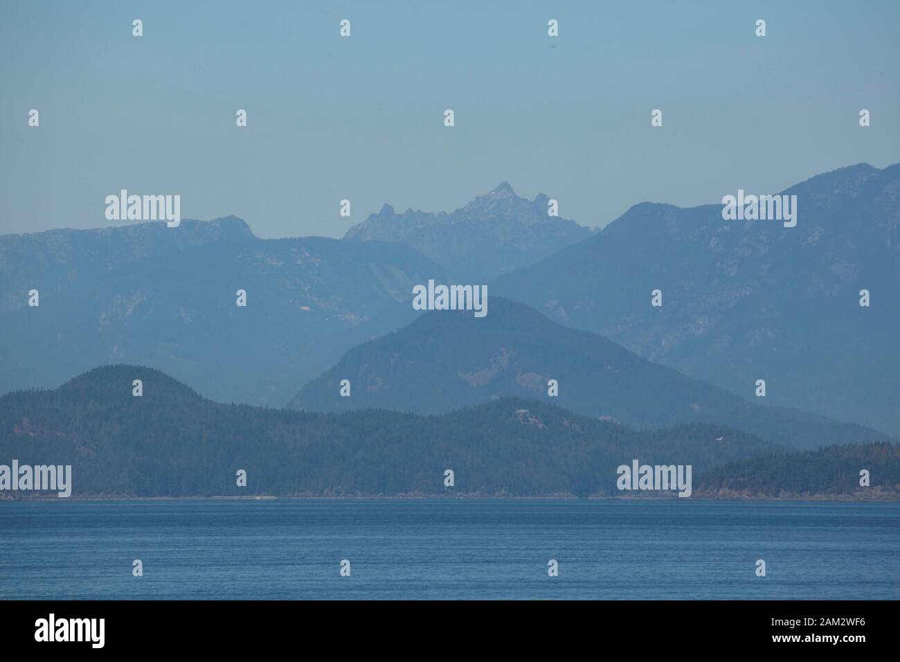 Mountain range seen across calm sea from Vancouver Island, British ...