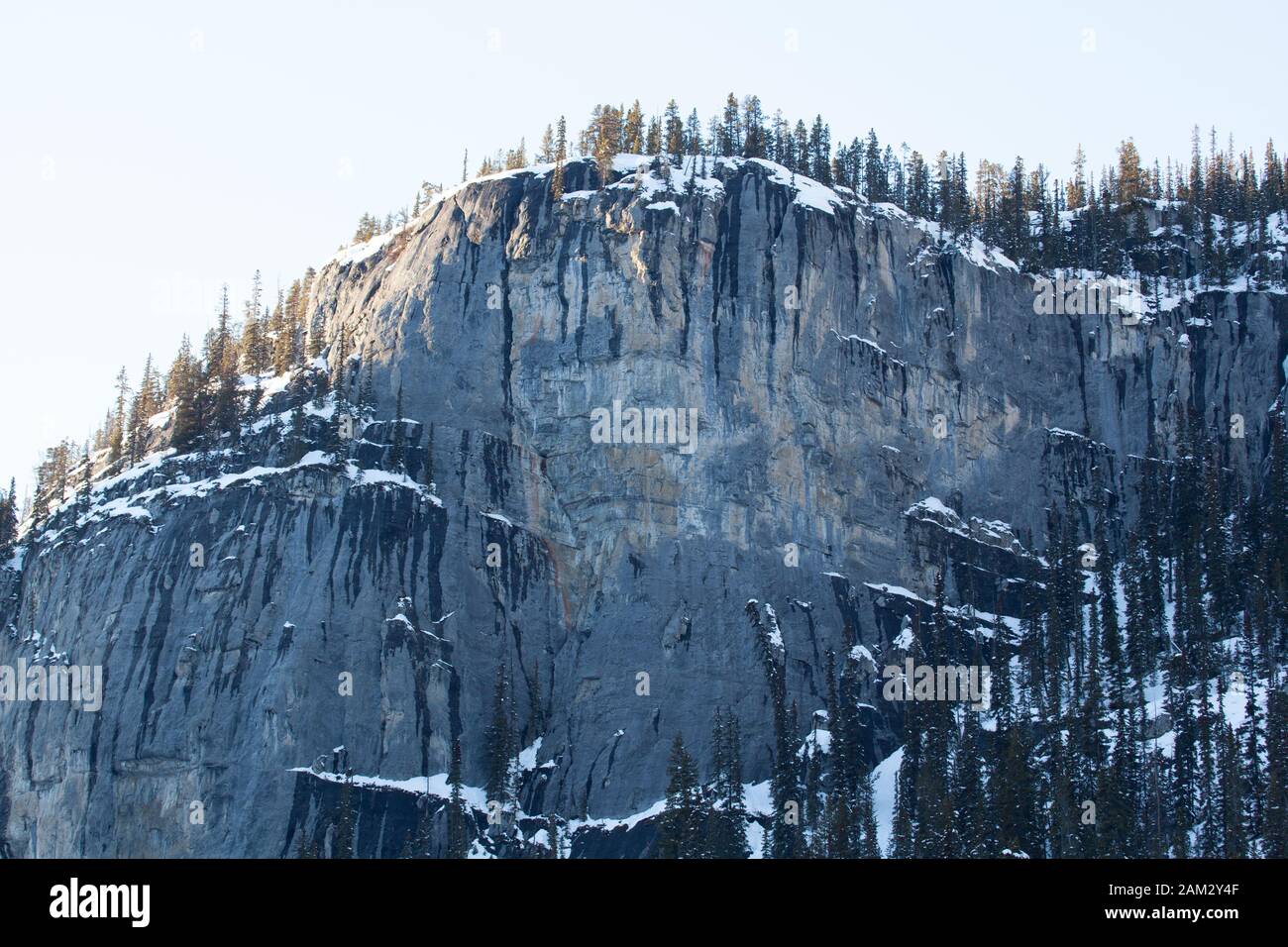 Sun falling on rockface of mountain range, Jasper National Park, Jasper ...