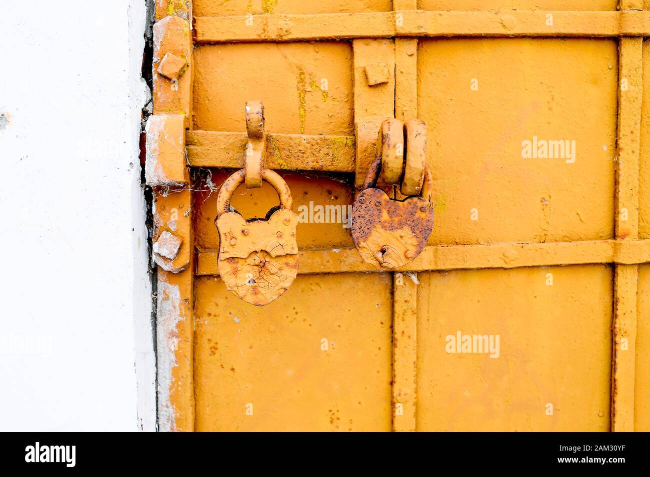 Lock with the bolt closed on the background of the antique-bound door ...