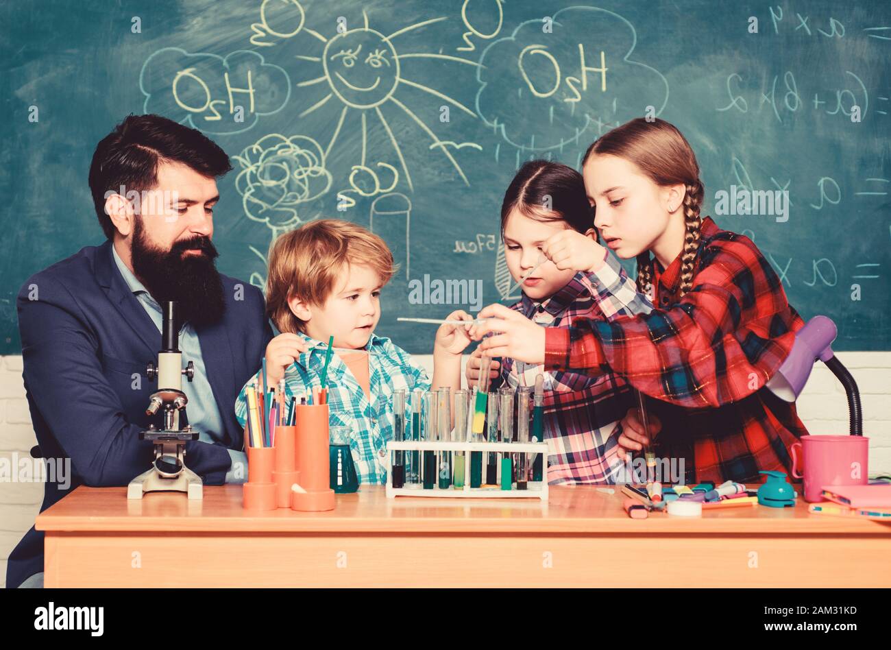 Little kids learning chemistry in school laboratory. school kids ...