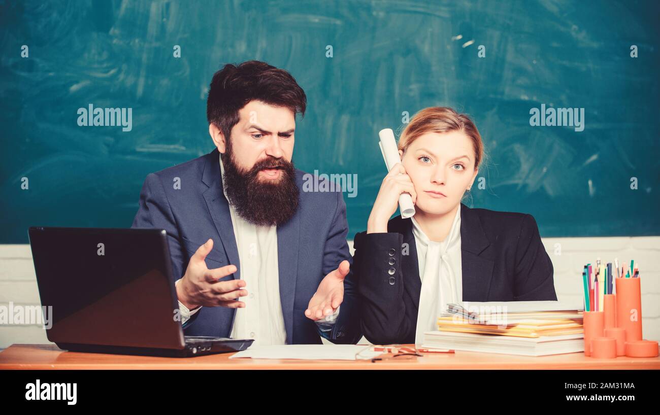 Teacher and supervisor working in school classroom. School educator and ...