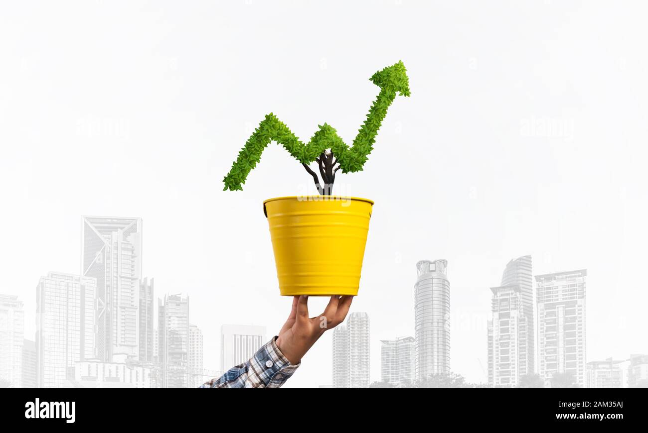 Green plant in shape of grow up trend Stock Photo - Alamy