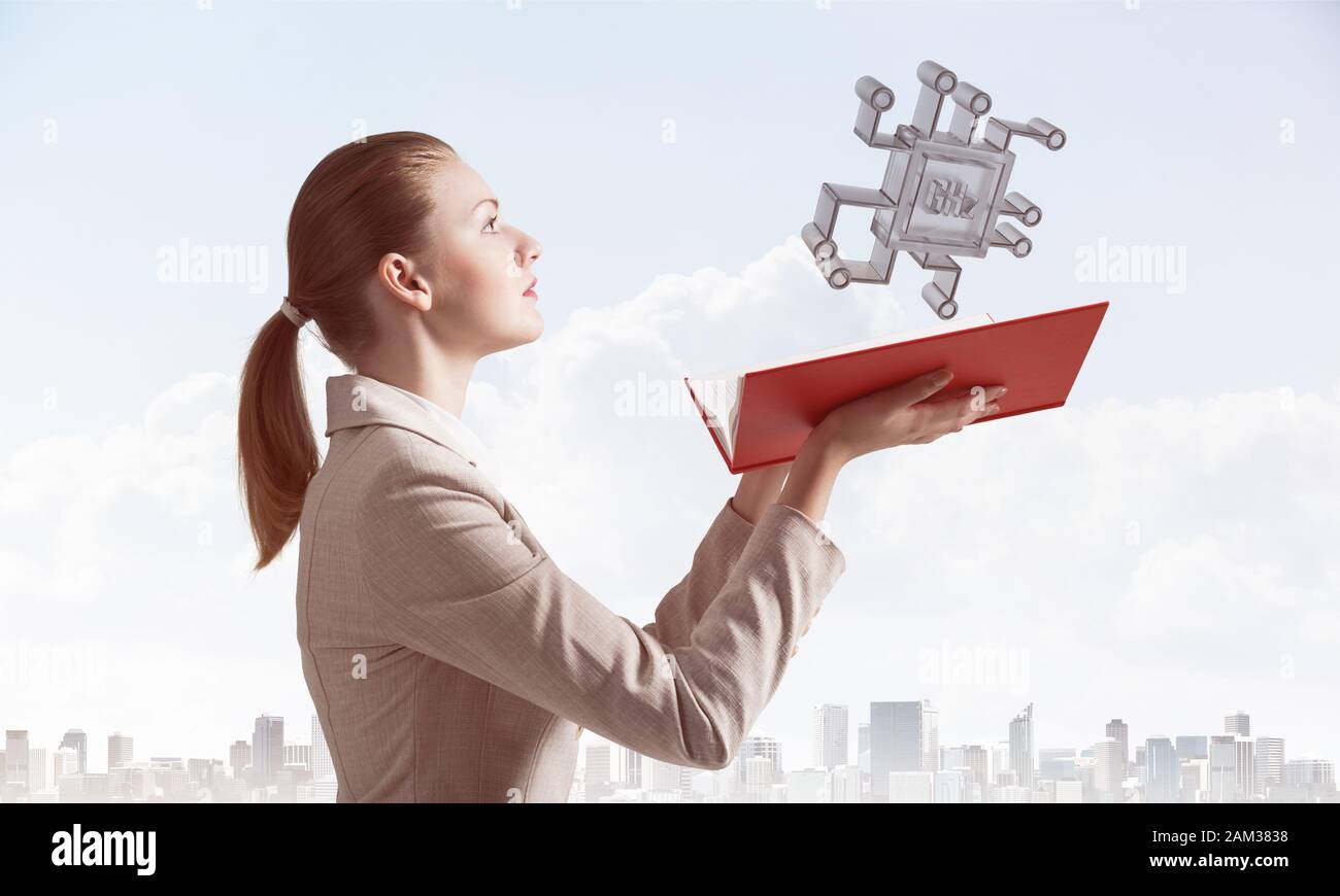 Woman holding book with flying electronic circuit Stock Photo - Alamy