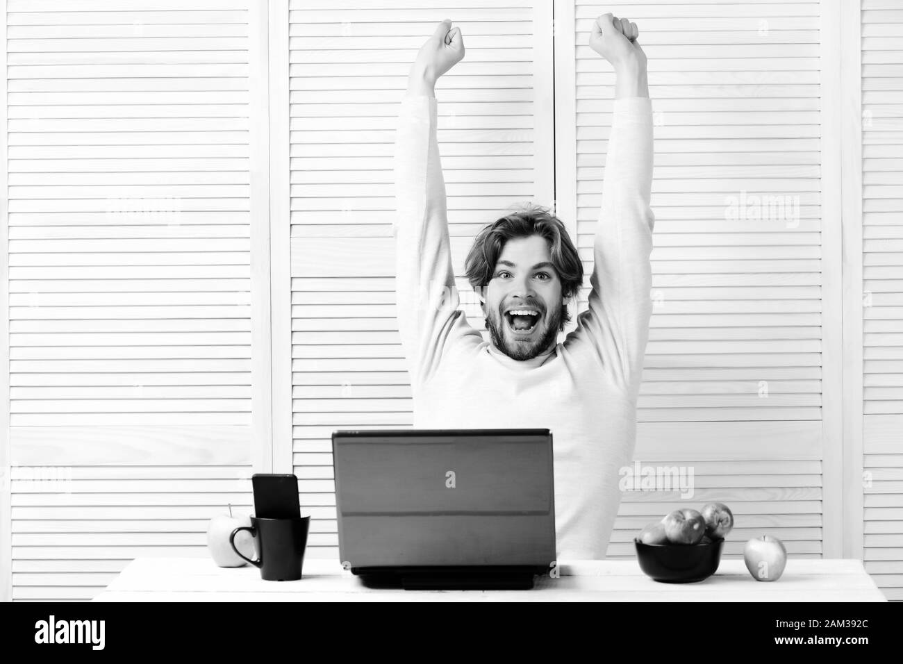 Smiling man sits desk Black and White Stock Photos & Images - Alamy